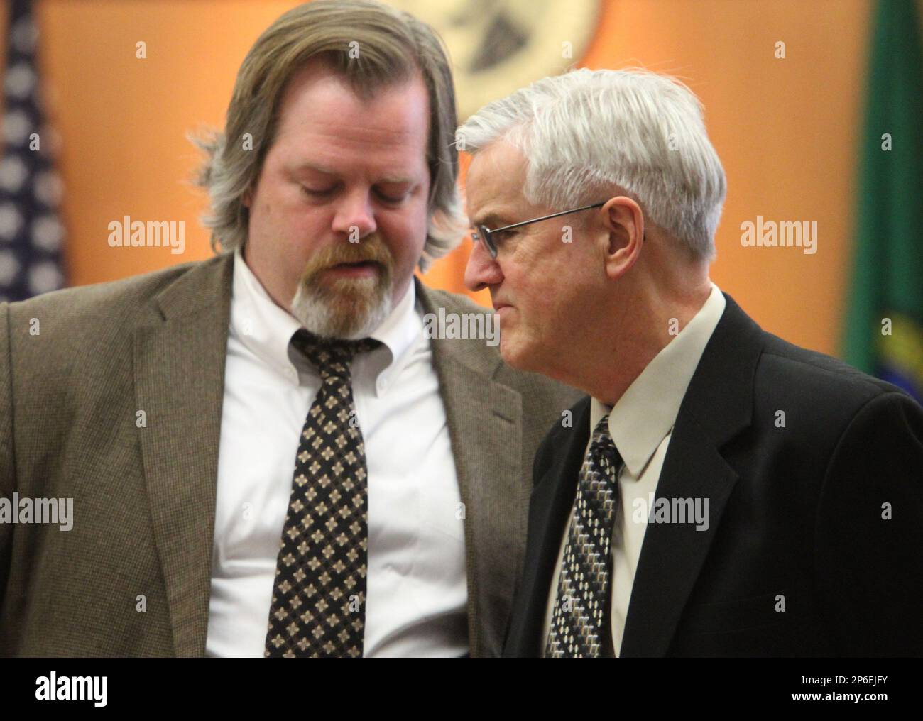 Defense attorney Travis Currie, left, talks to Steve Powell of the ...