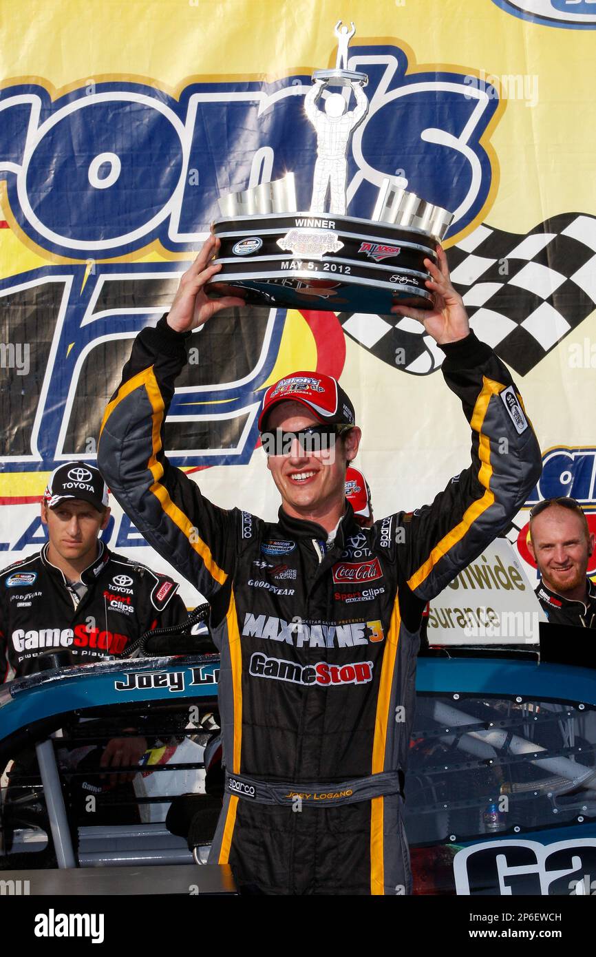 Joey Logano holds the trophy in victory lane after winning the NASCAR ...