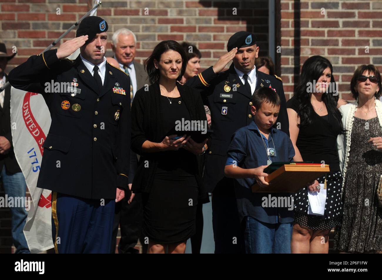 Camille Workman and her son Cole Hayes watch as the casket of their ...