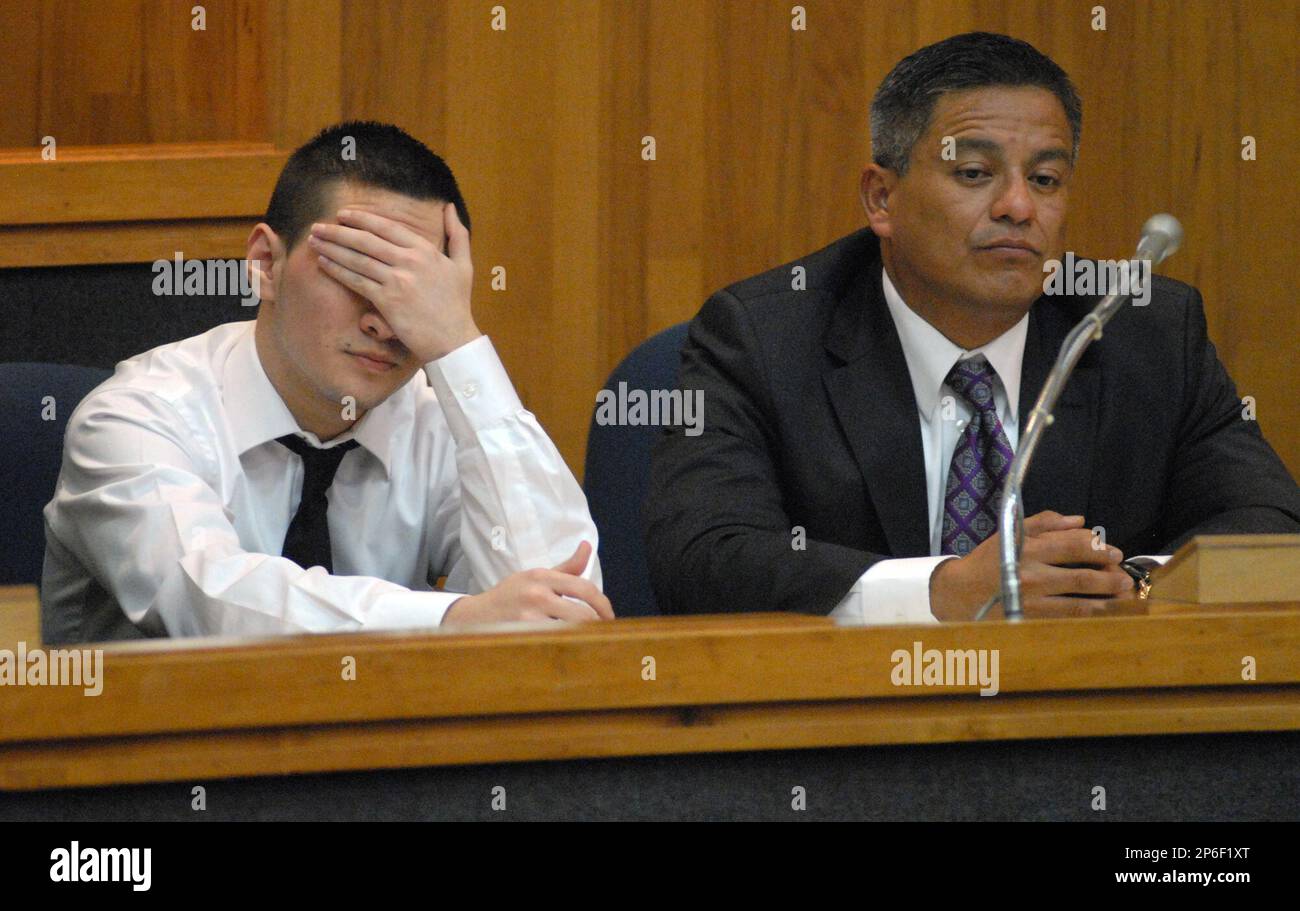 Javier De La Rosa stared covers his face as he sits next to defense ...