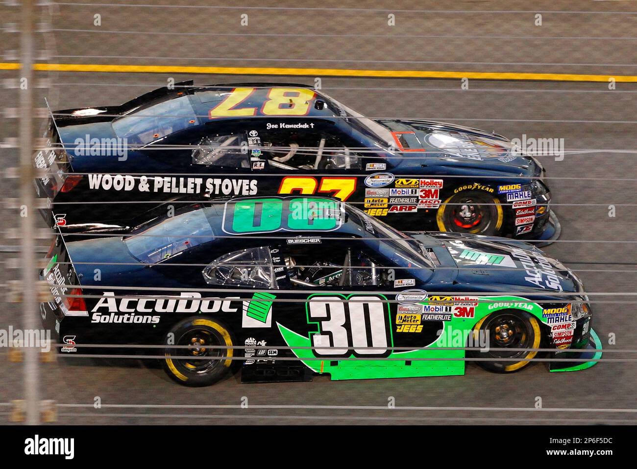 James Buescher (30) and Joe Nemechek (87) during Friday's NASCAR ...