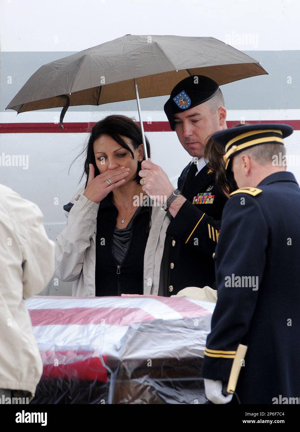 Camille Workman looks down at the flag draped casket of her husband ...