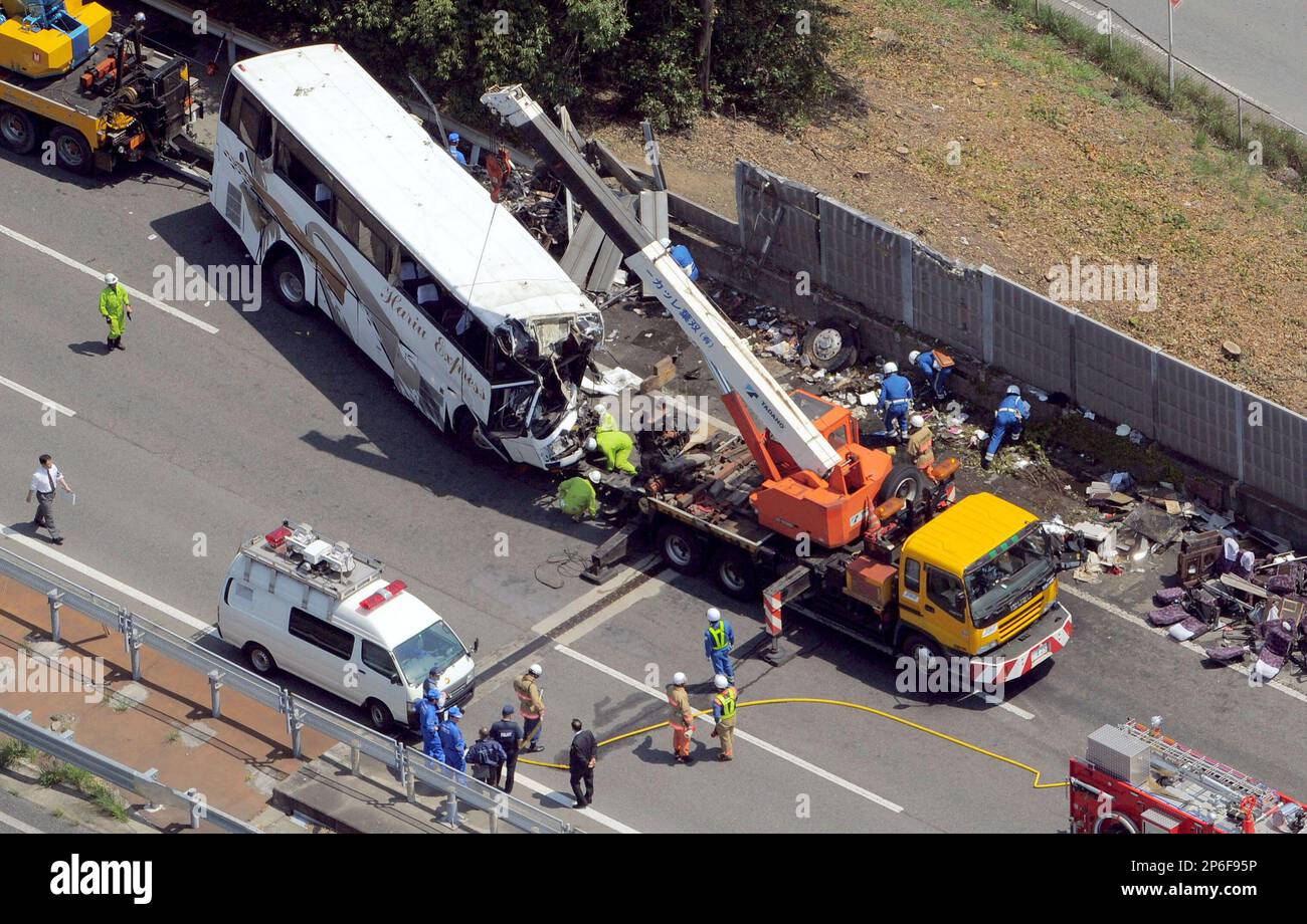 The wreckage of a destroyed bus is removed from a highway after an ...