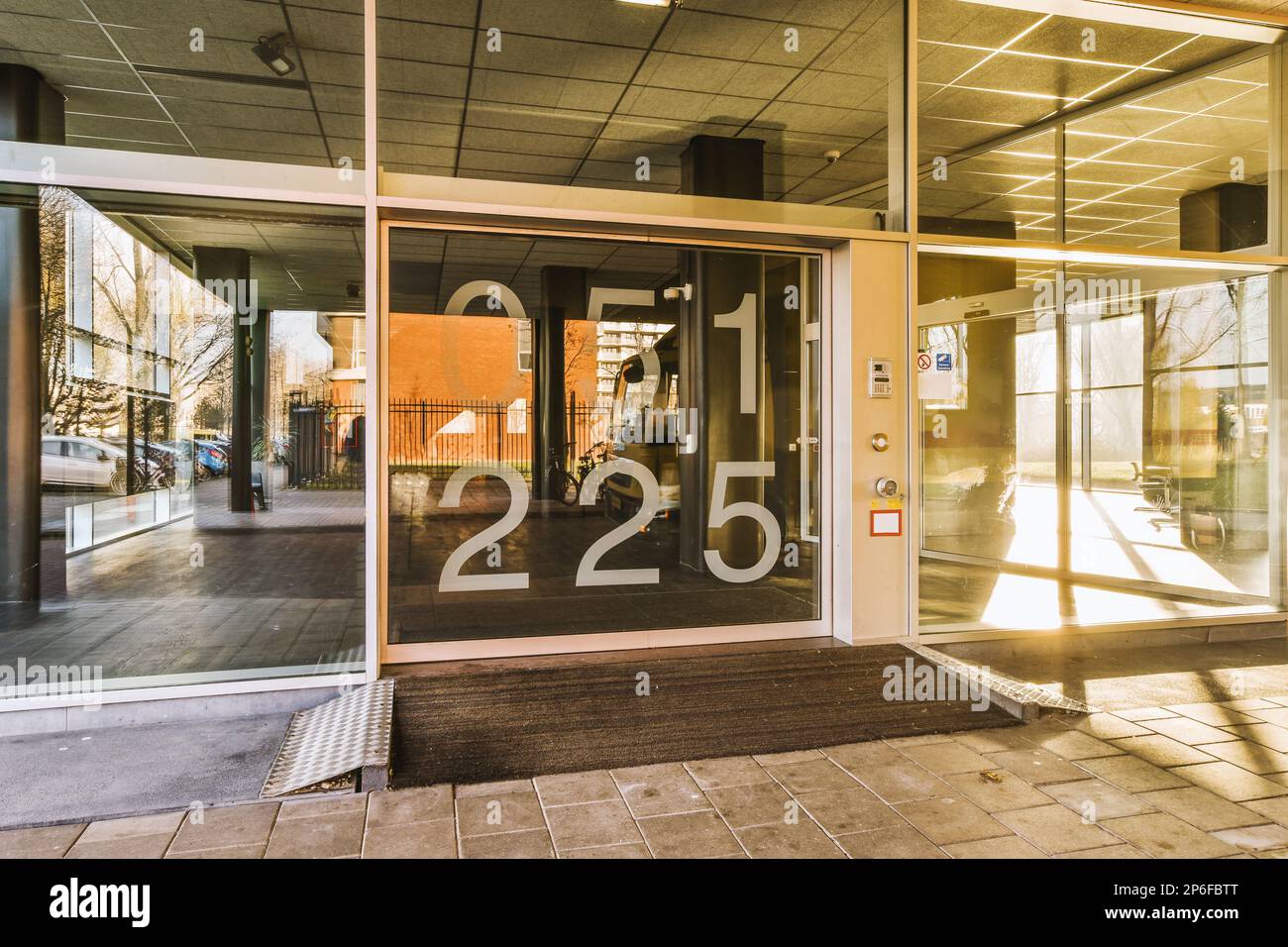 a store front door with the number 26 on it's glass doors are open and ...