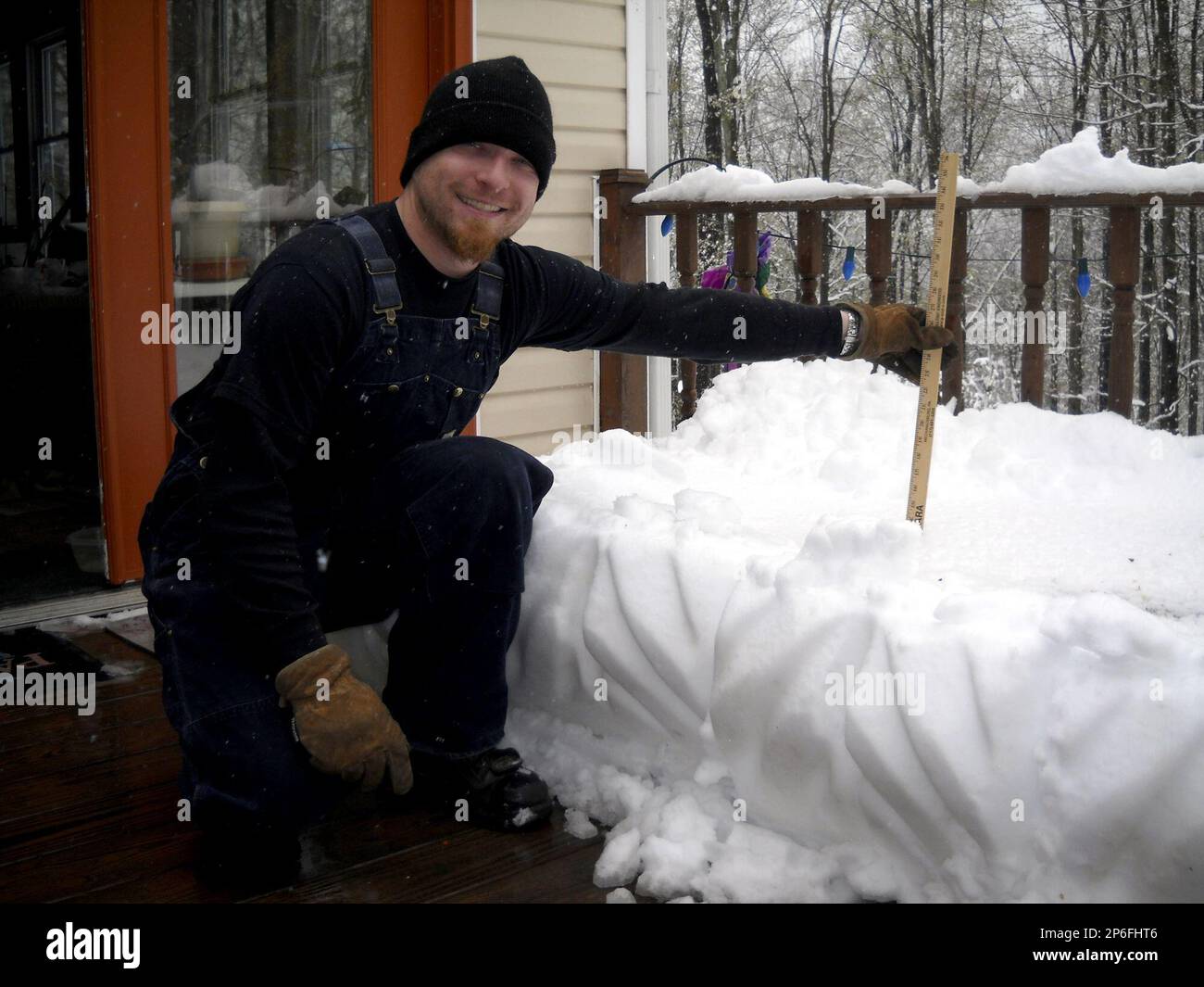 Nick Brogan shows how deep the snow was on Mallory Babcock's porch on ...