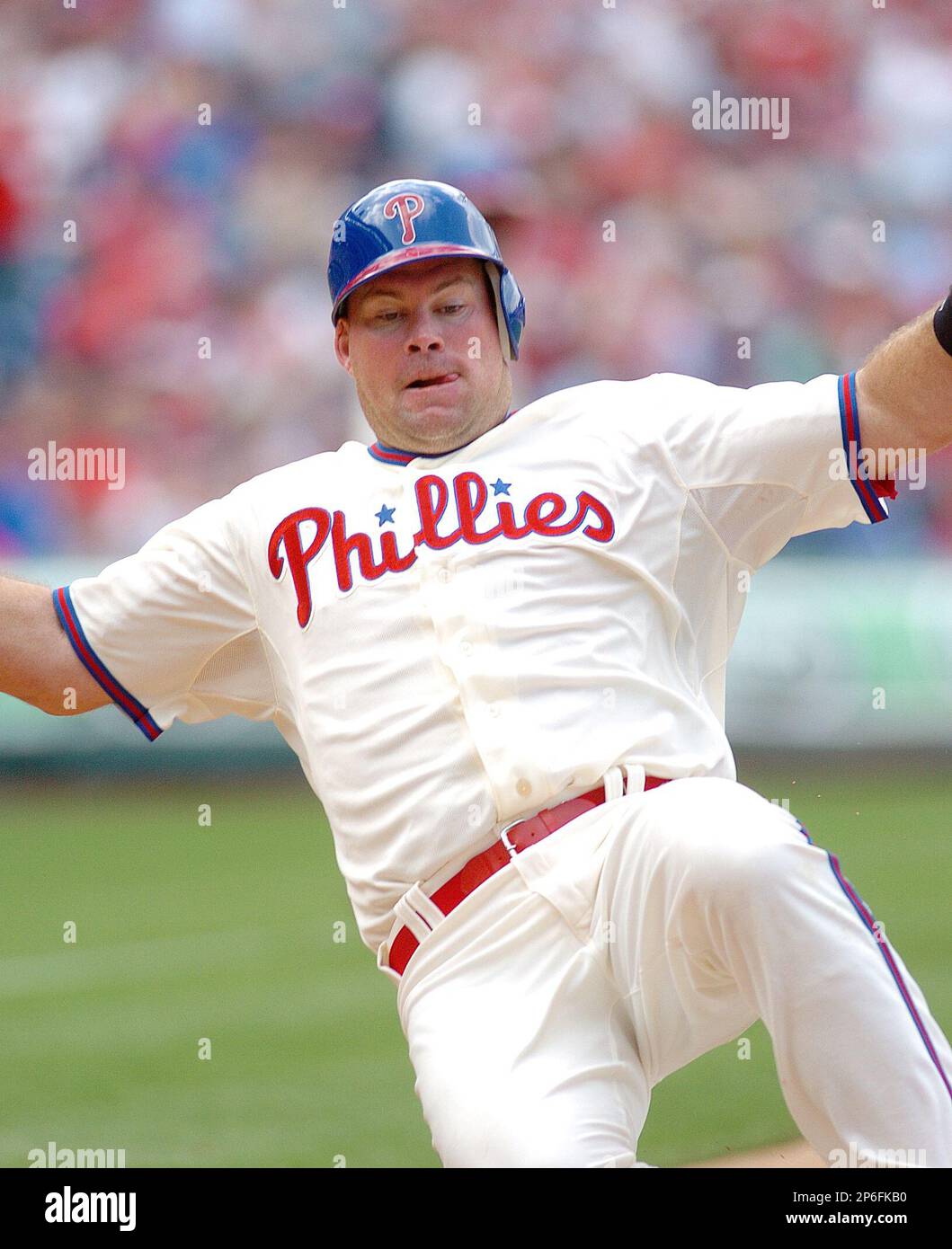 Philadelphia Phillies infielder Ty Wigginton slides into the plate on ...