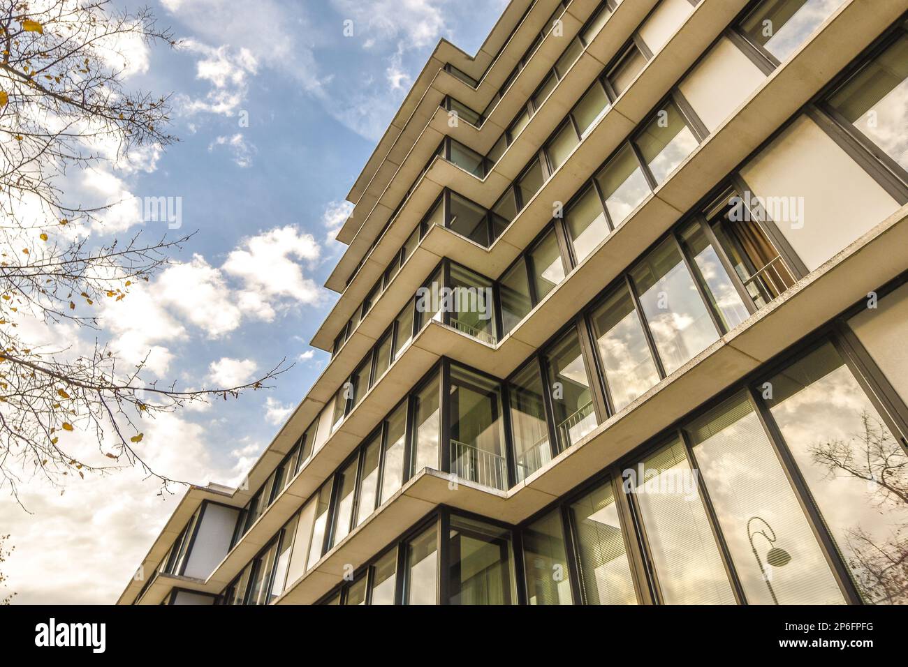 an office building with windows and trees in the fore - eyed photo is ...