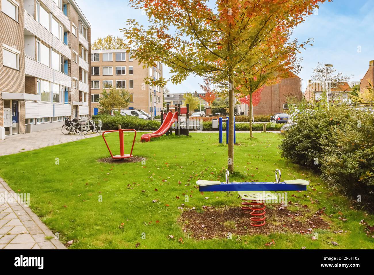 a park in the middle of an urban area with playgrounds and children's ...