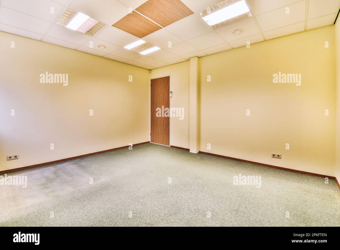 an empty room with light coming in through the ceiling and door to ...