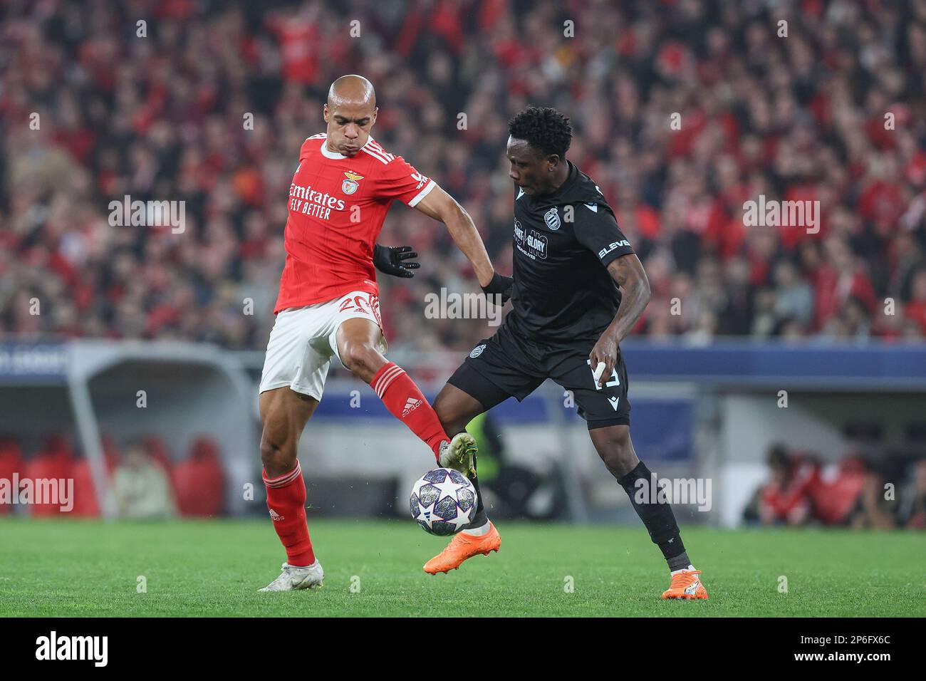 Benfica's Joao Mario and Club's Kamal Sowah fight for the ball during a ...