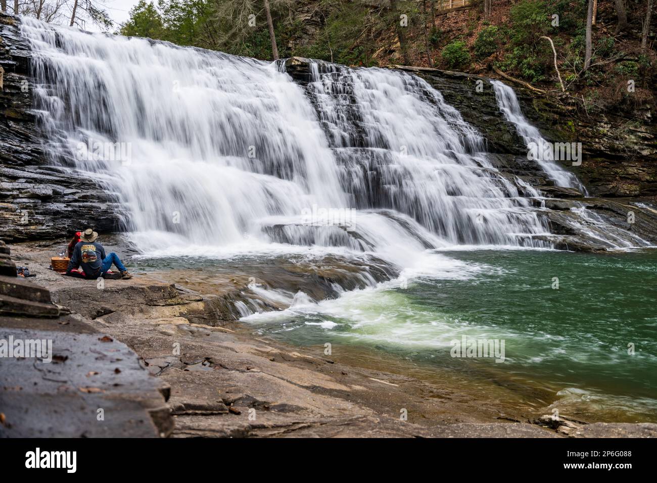 Two Visitors enjoying the view of one of the many beautiful waterfalls ...
