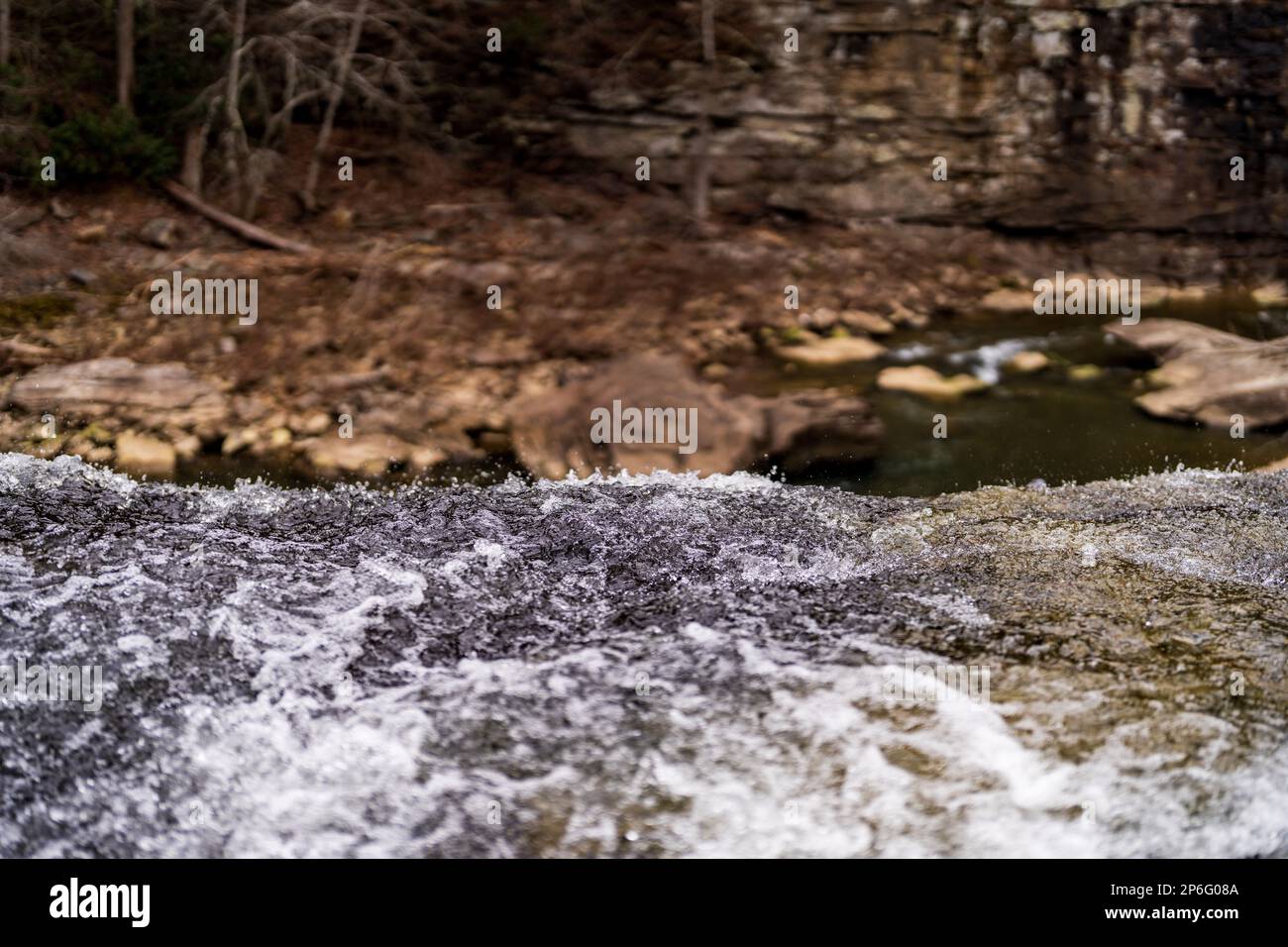A steam drifting between majestic rocks and lush trees Stock Photo - Alamy