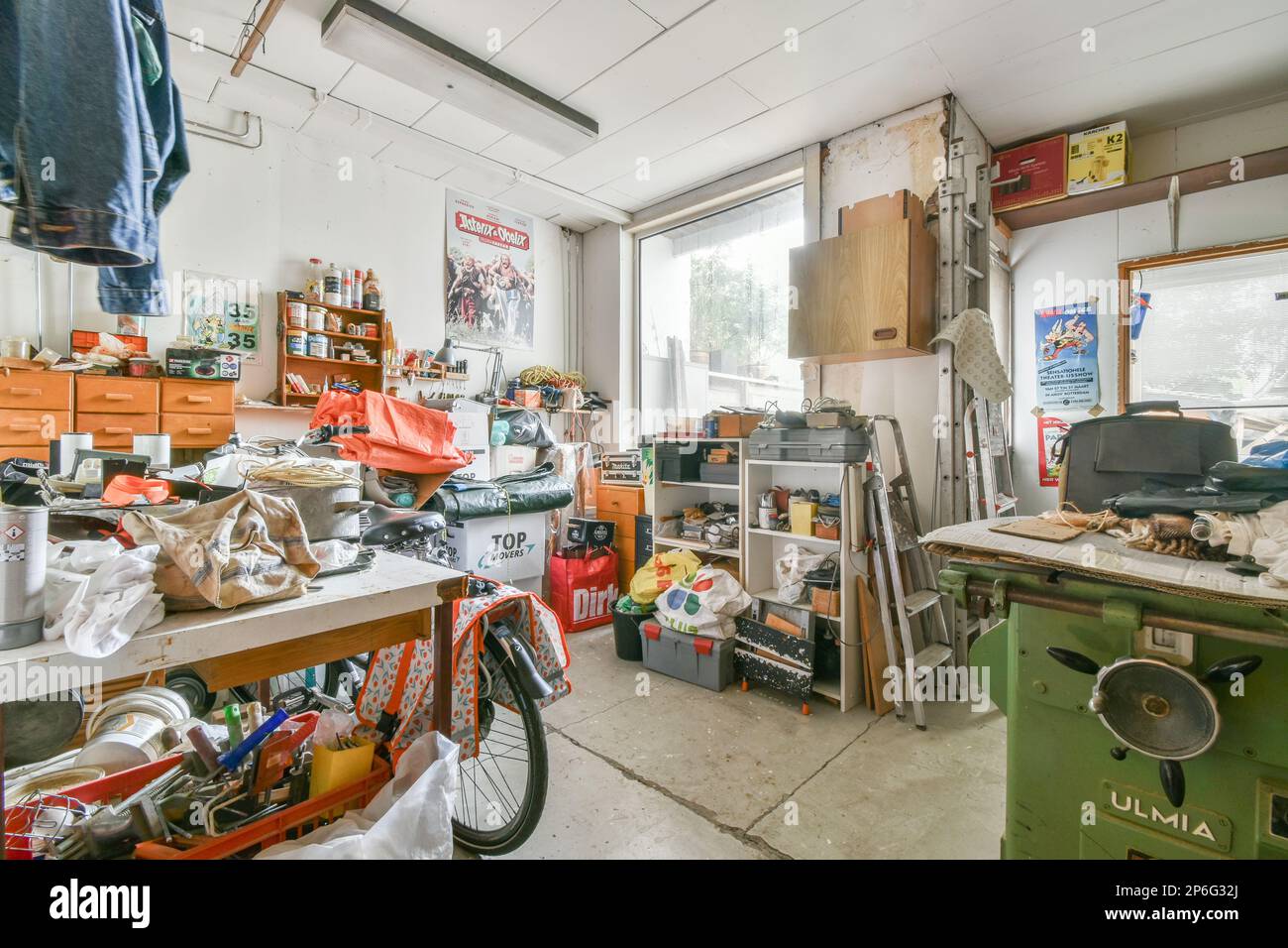 a messy garage with lots of clutters on the floor and tools in the area ...