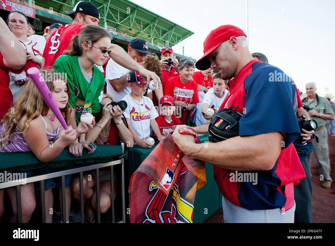 Skip Schumaker (55) of the St. Louis Cardinals signs autographs for ...