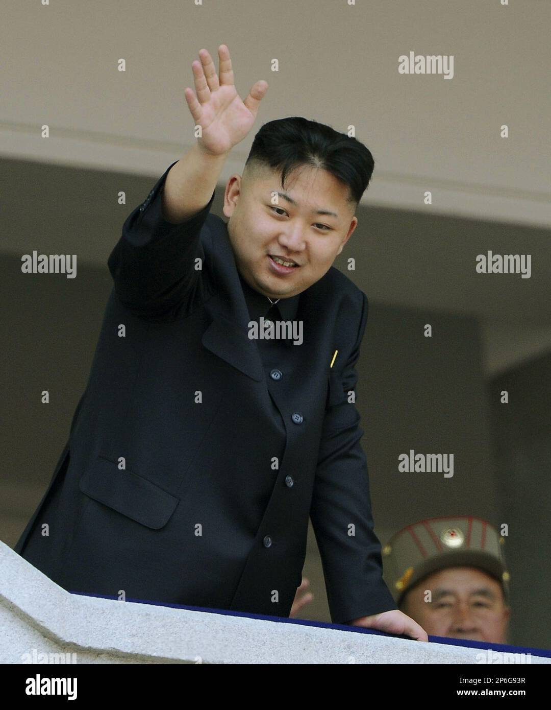 North Korean leader Kim Jong Un waves during a mass military parade at ...