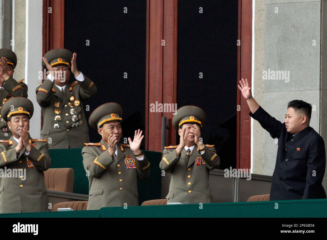 North Korean leader Kim Jong Un, left waves as North Korean military ...