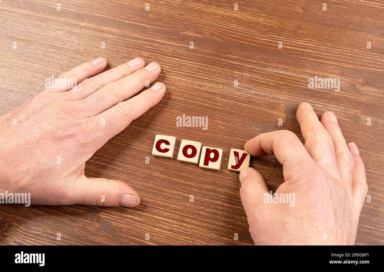 the word Copy formed with small wooden tablets on a colored surface ...