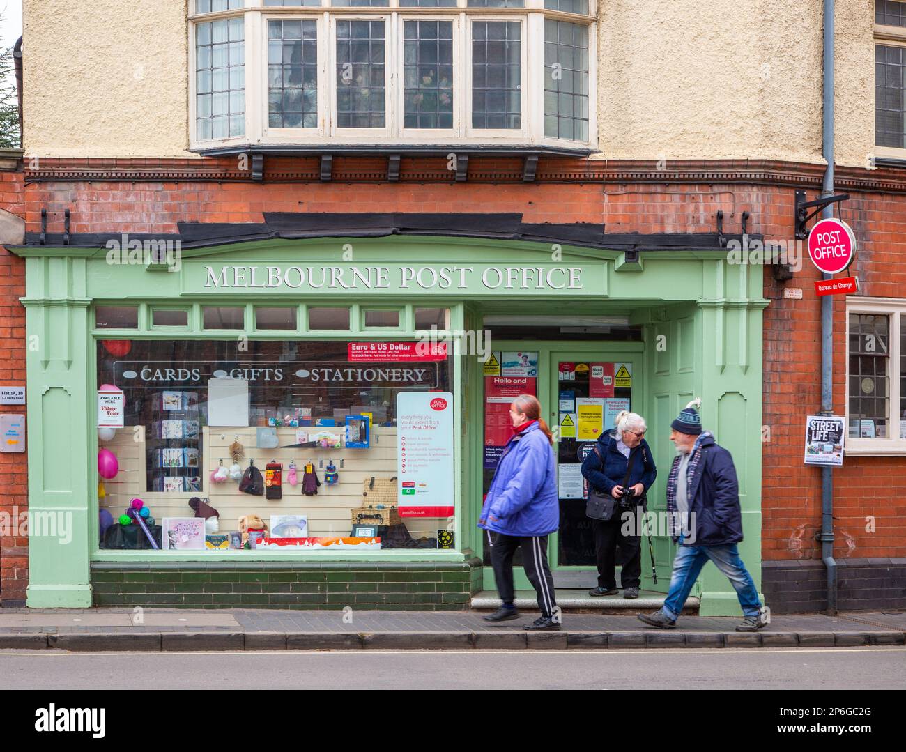 People walking past and coming out of the old traditional post office ...