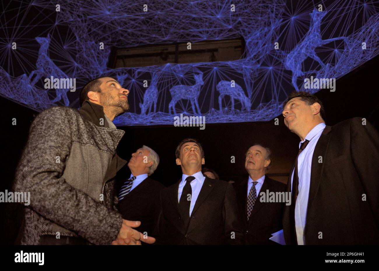 French President Nicolas Sarkozy, center, artist Julien Salaud, left ...