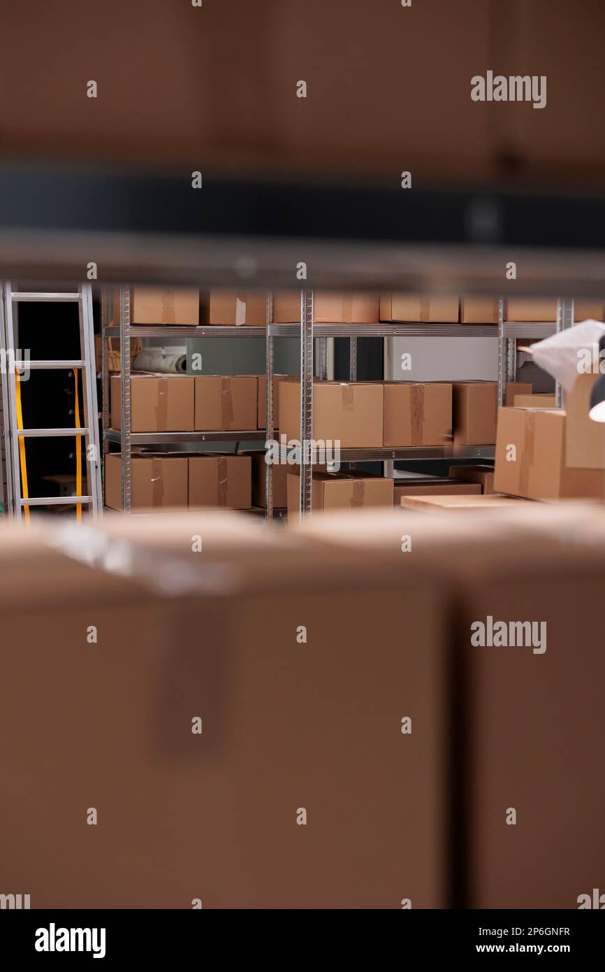 Selective focus of tall metal shelves filled with various cardboard ...