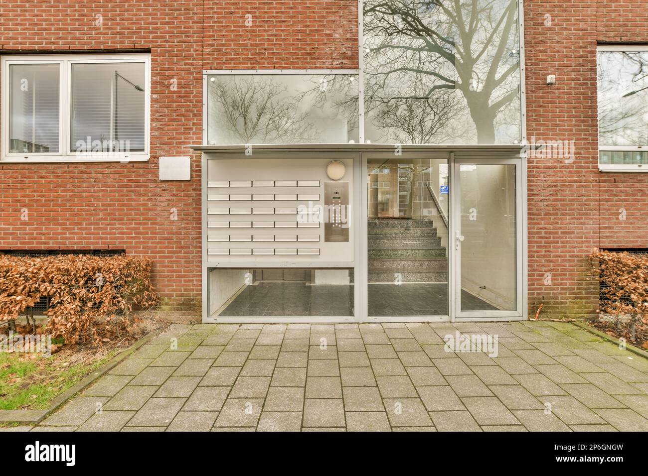 a brick building with an elevator in the middle and two windows on the ...