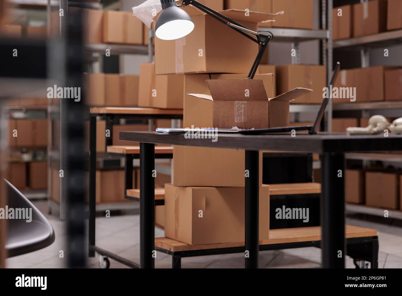 Empty warehouse equipped with tall shelves full with cardboard boxes ...