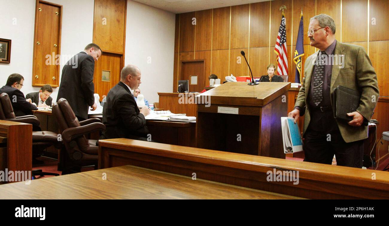 Great Bend Police detective Denton Doze, right, leaves the courtroom ...