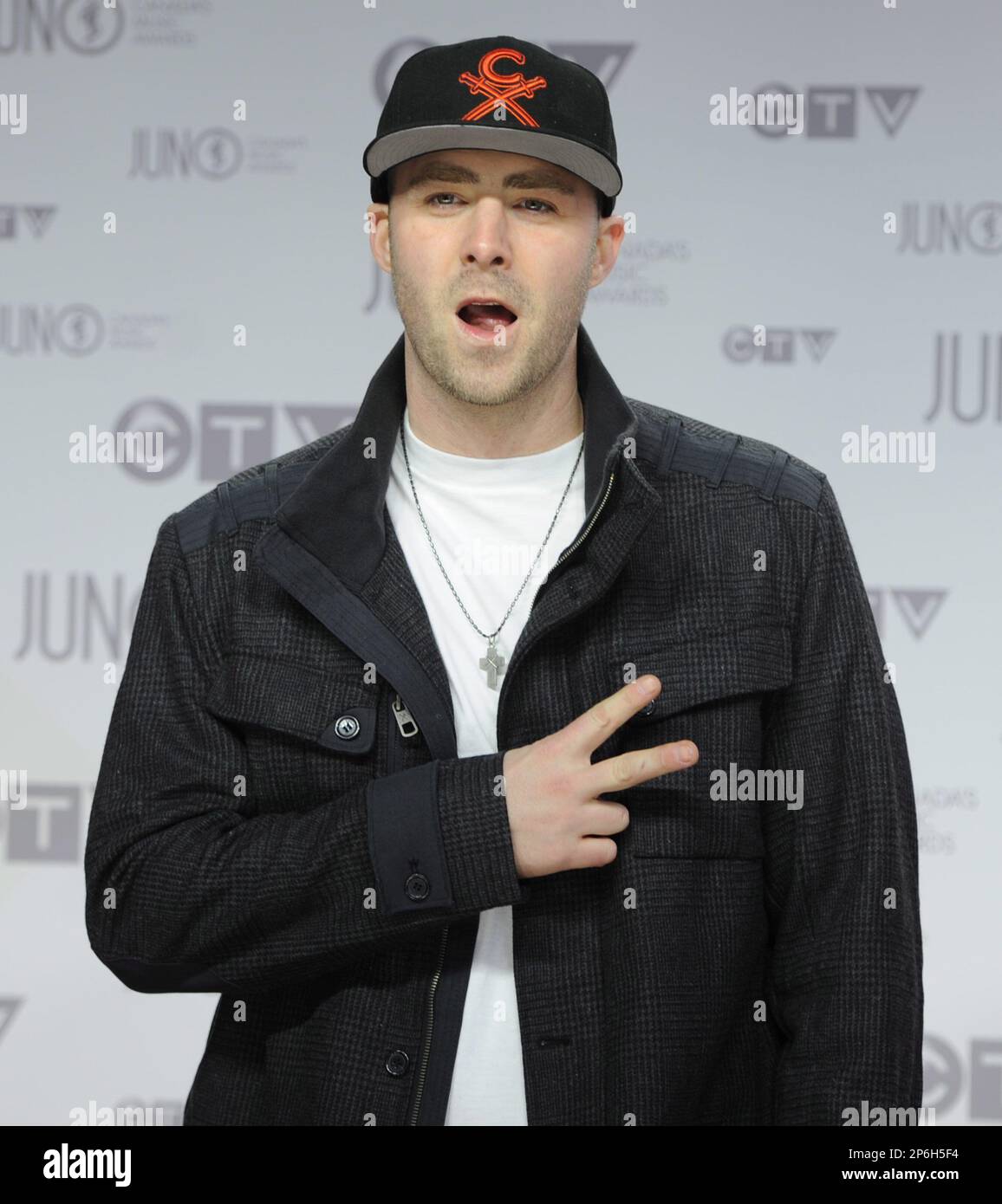 Rapper Classified poses for photographers as he arrives on the red ...
