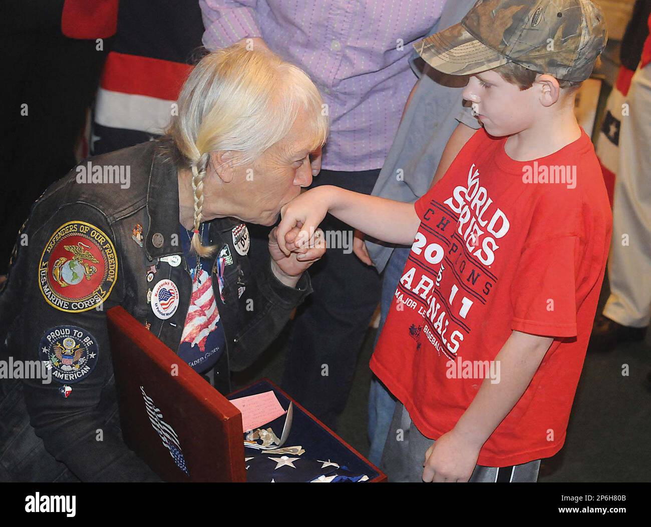 Sandy Hart kisses the hand of Dalton Reno, 6, of Wickliffe, Ky ...