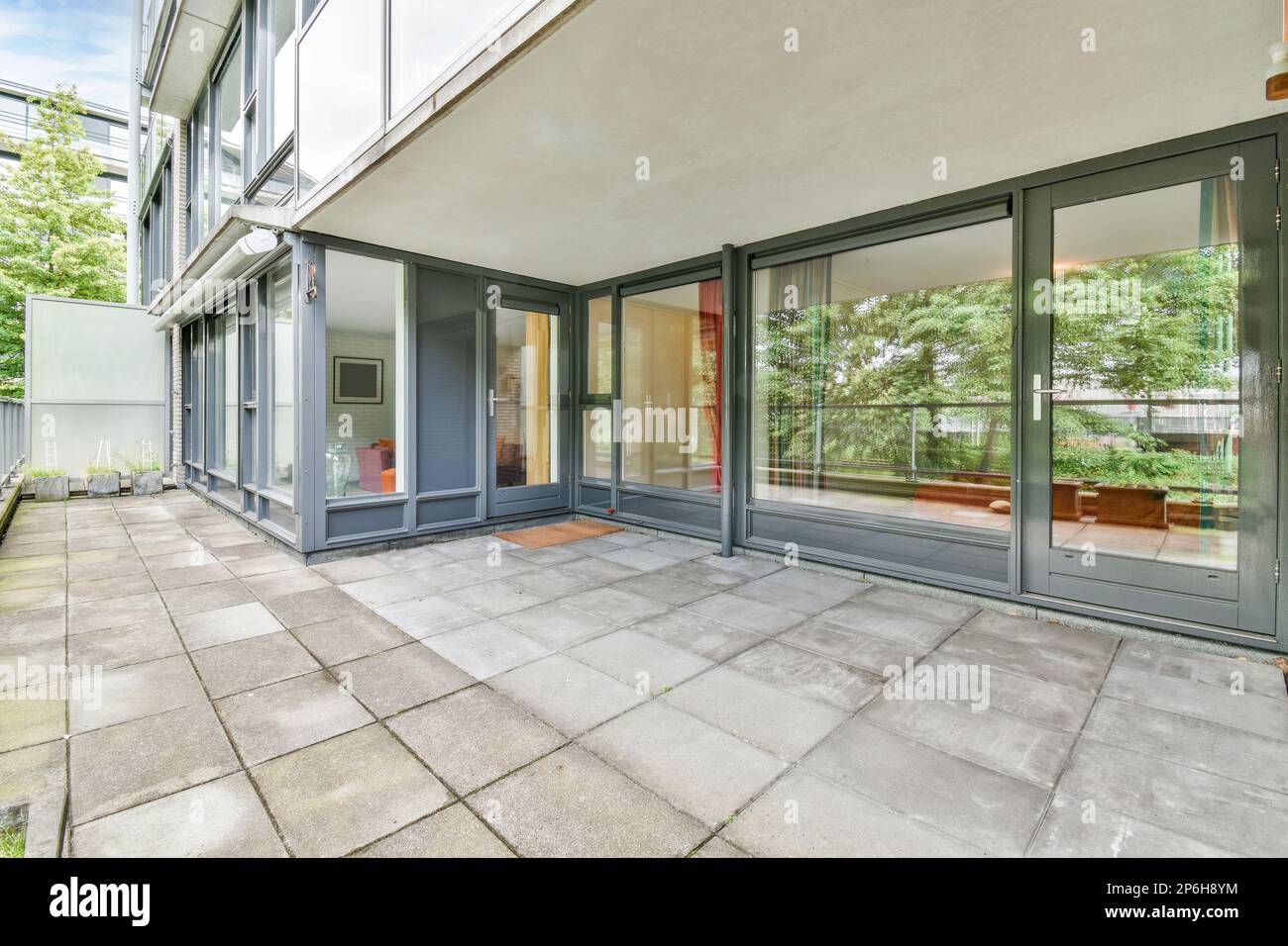 an outside area with patio and sliding glass doors that open up to the ...