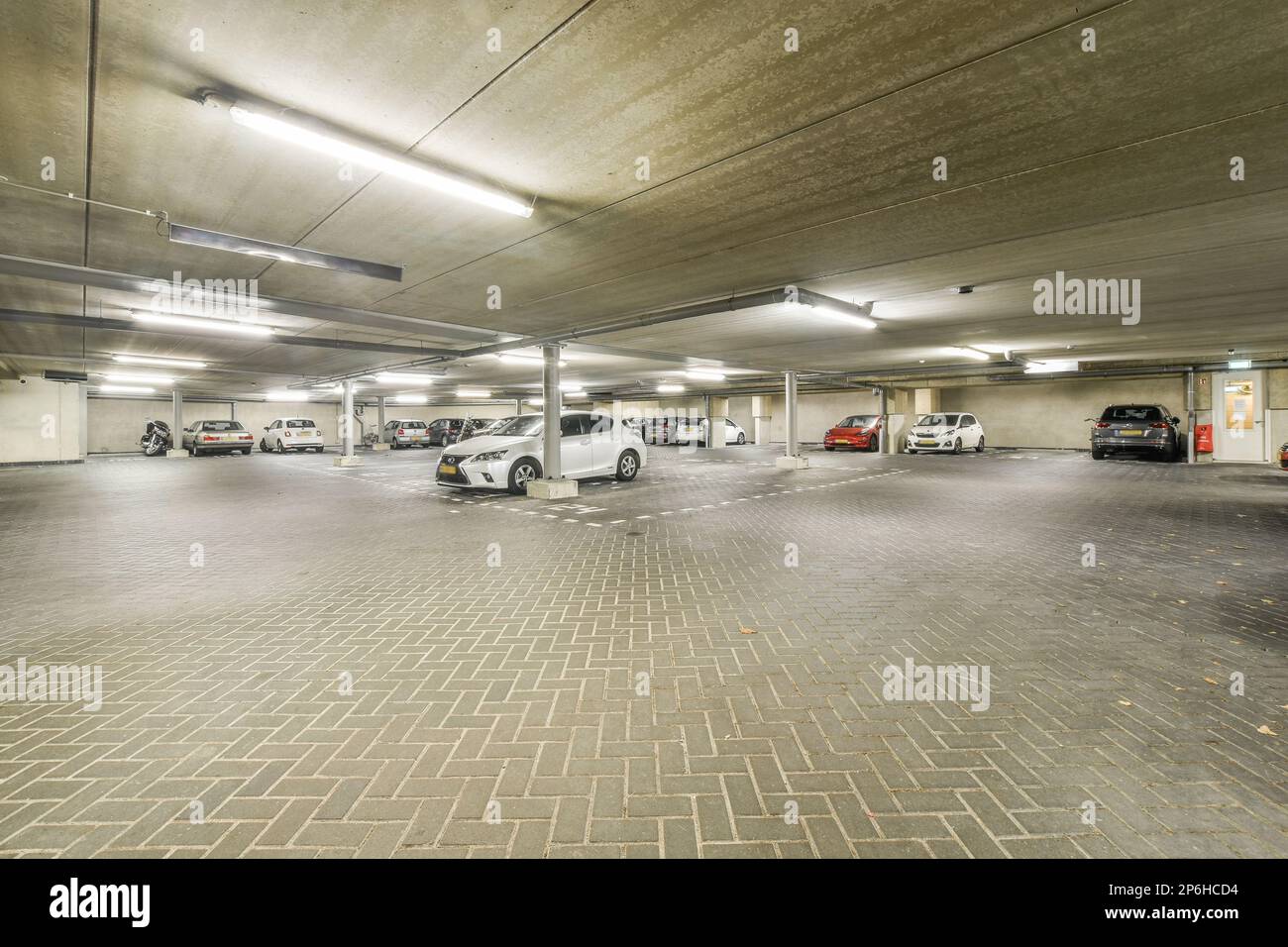 an underground parking area with cars parked in the garages on either ...