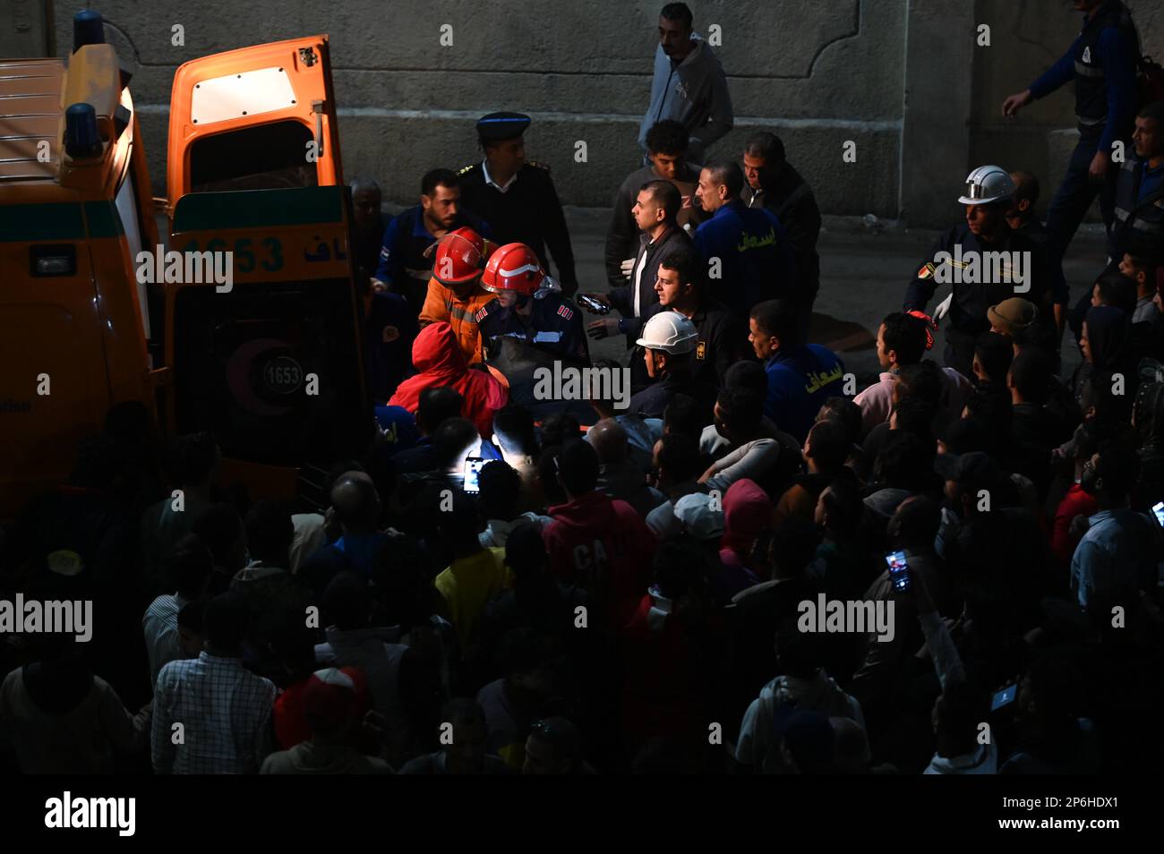 Qalyubia Governorate, Egypt. 07th Mar, 2023. Rescue workers gather around an ambulance vehicle ...