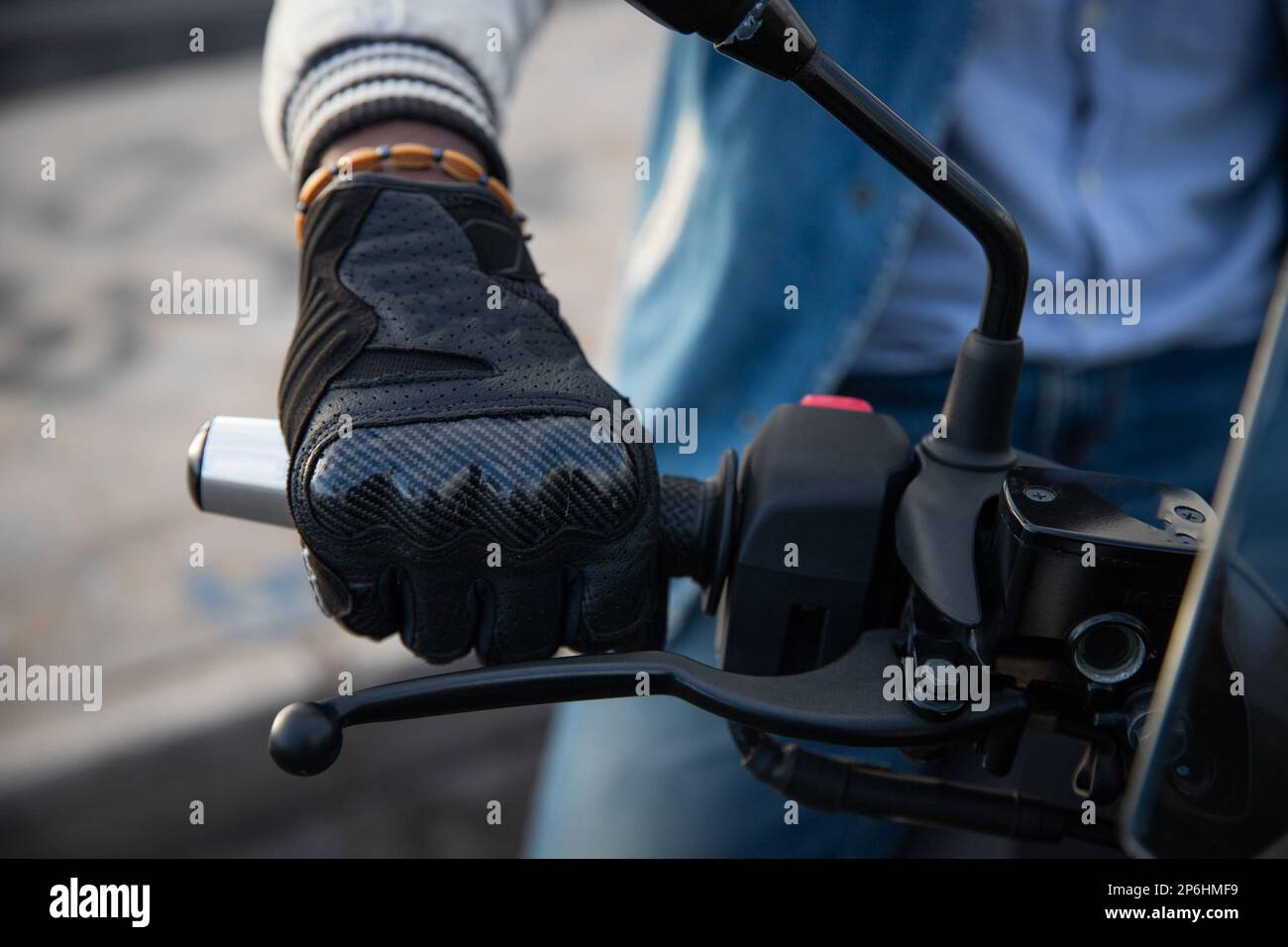 Close-up of an african biker's hand holding the handlebars of his ...