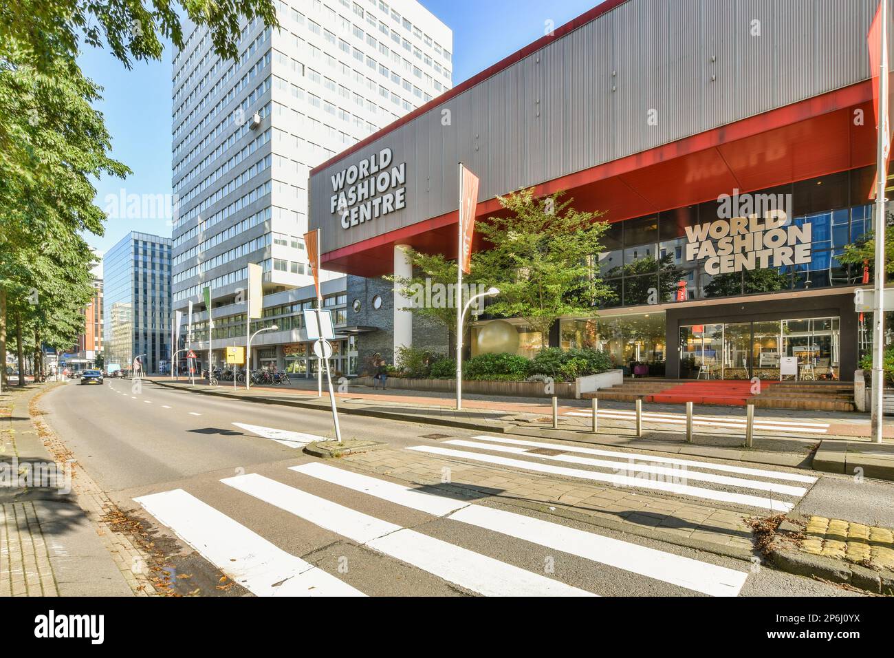 a city street with buildings in the background and white crosswalks on ...