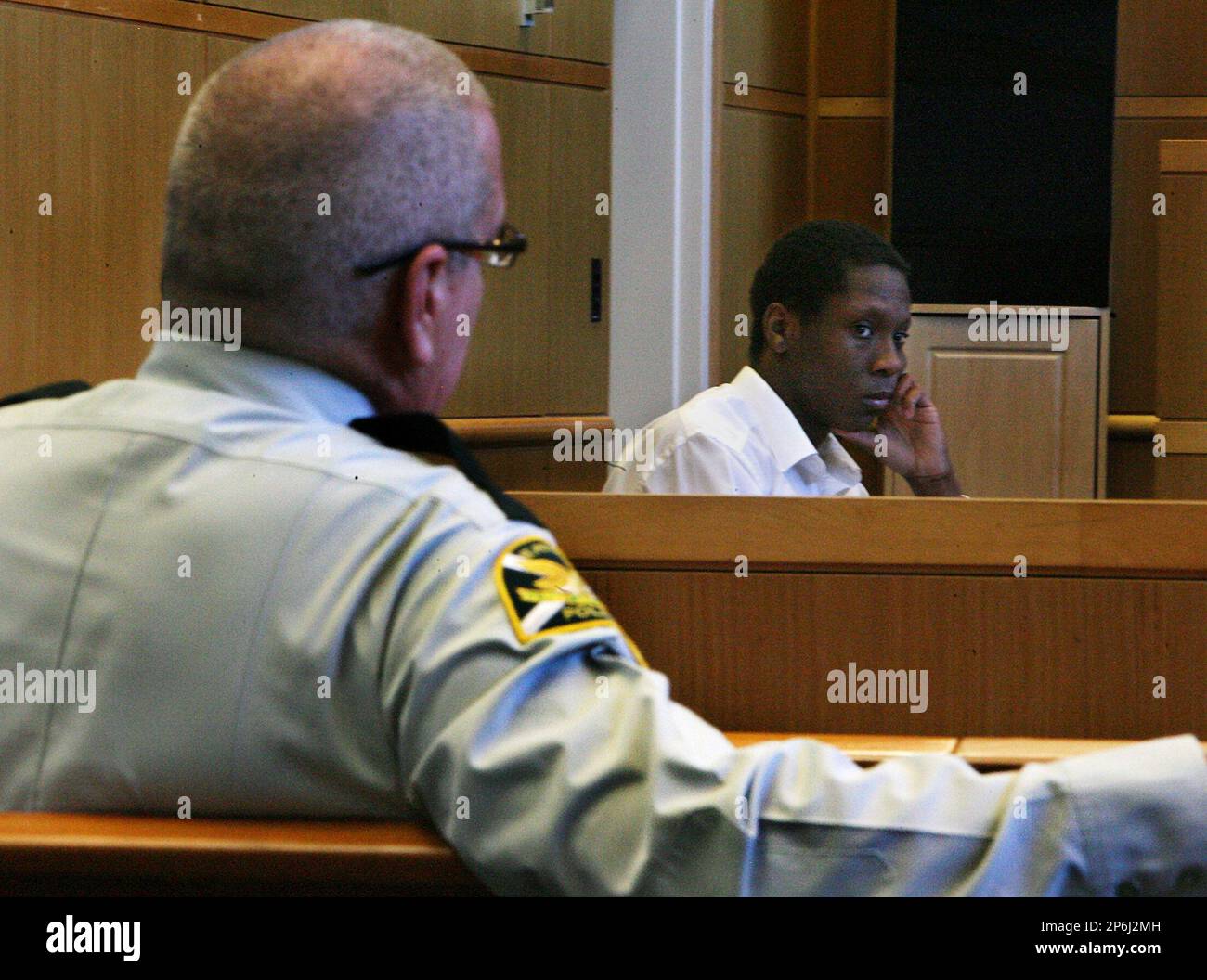 Murder defendant Nicholas Lindsey, back, right, listens as potential ...