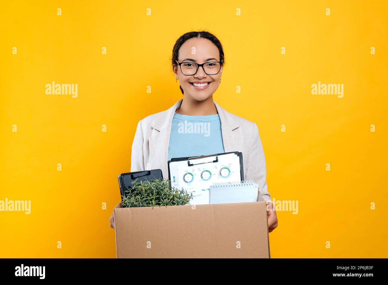 Newcomer girl got new job. Positive mixed race young woman with glasses ...