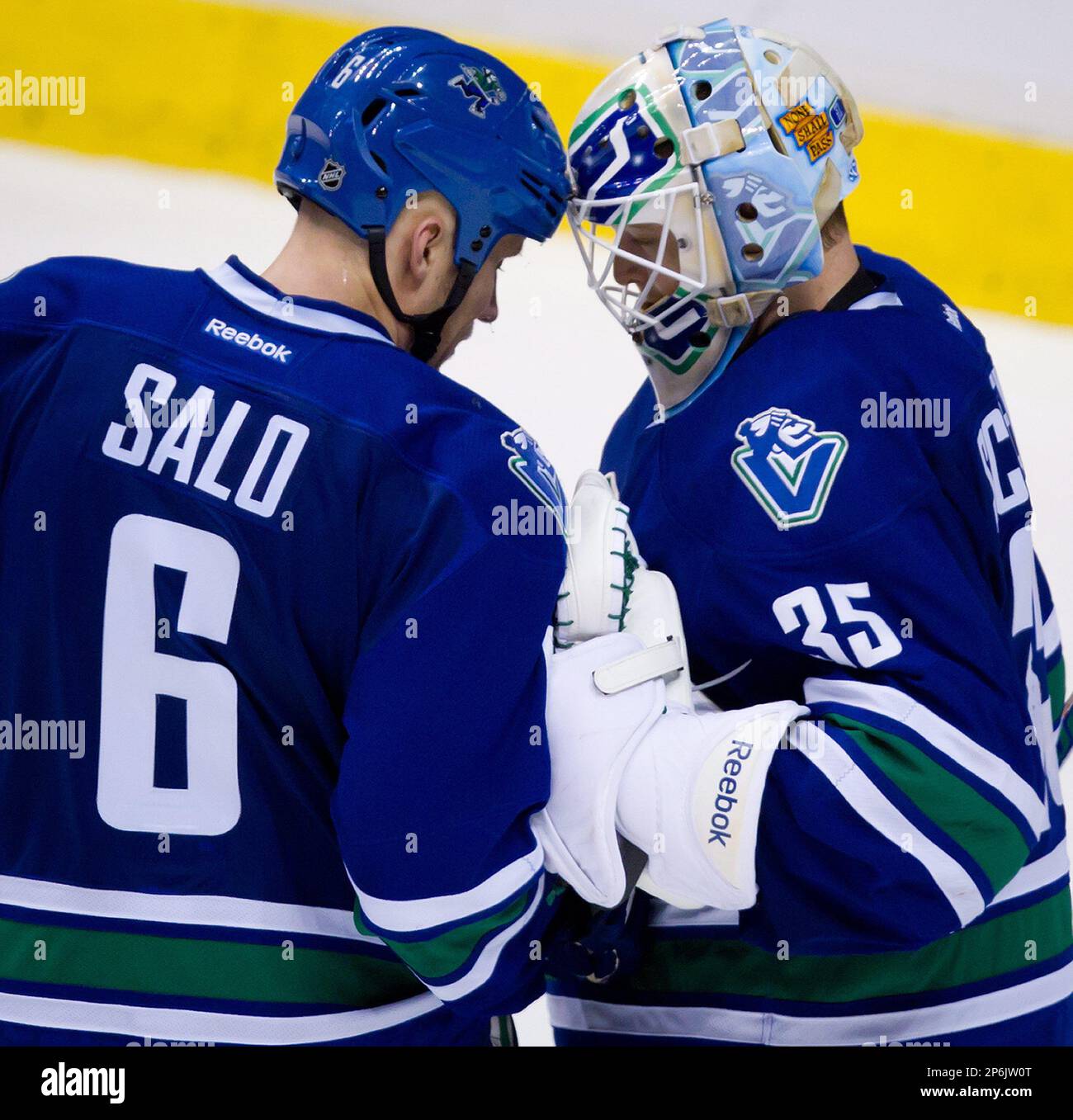 Vancouver Canucks' Sami Salo, left, of Finland, congratulates goalie ...