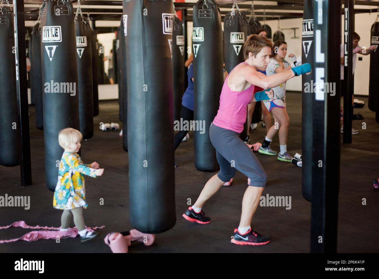 Emery Thomas, 2, works on her right hook as she joins her mother Angie ...