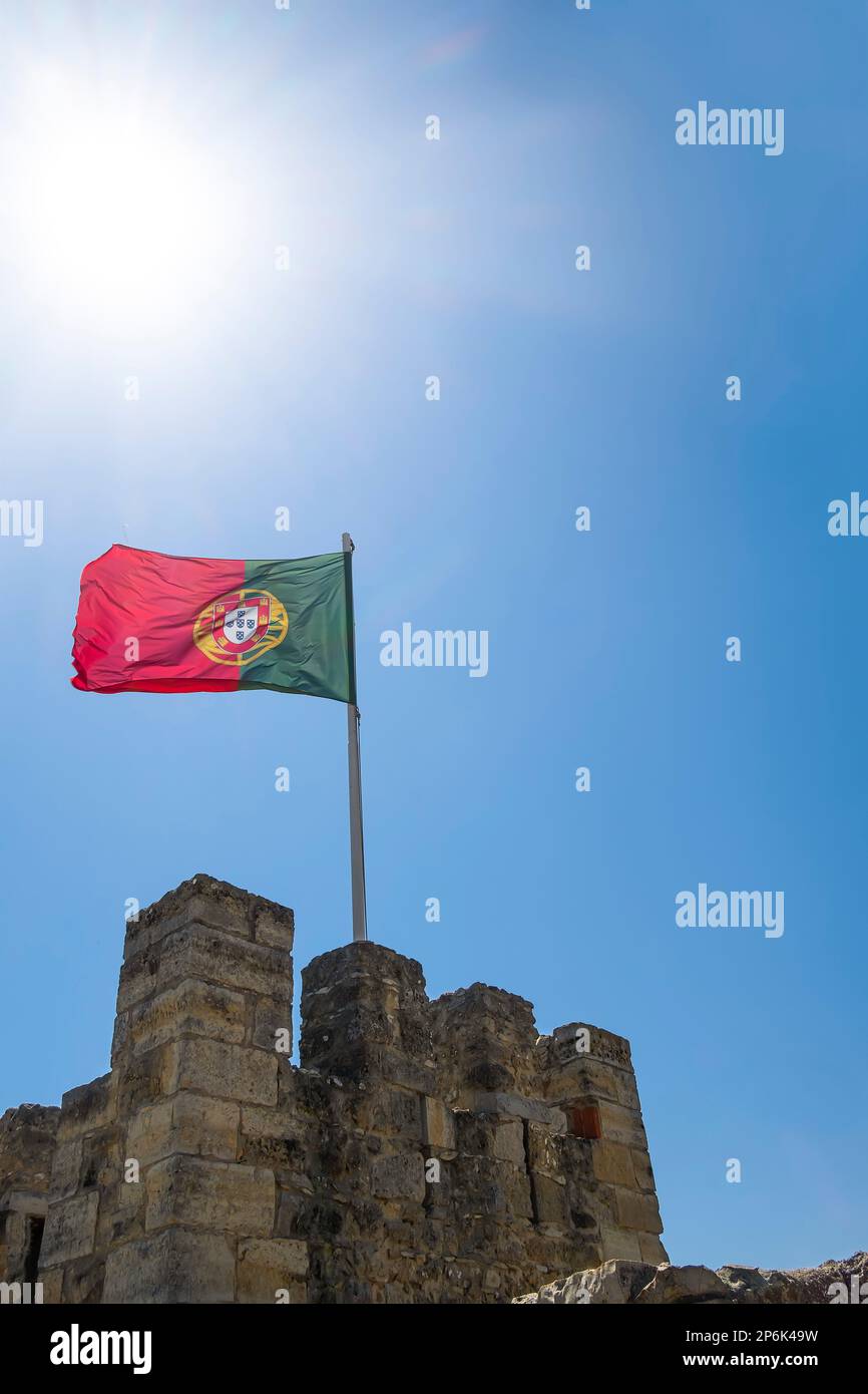 the national flag of portugal flies on top of a battlement of the ...
