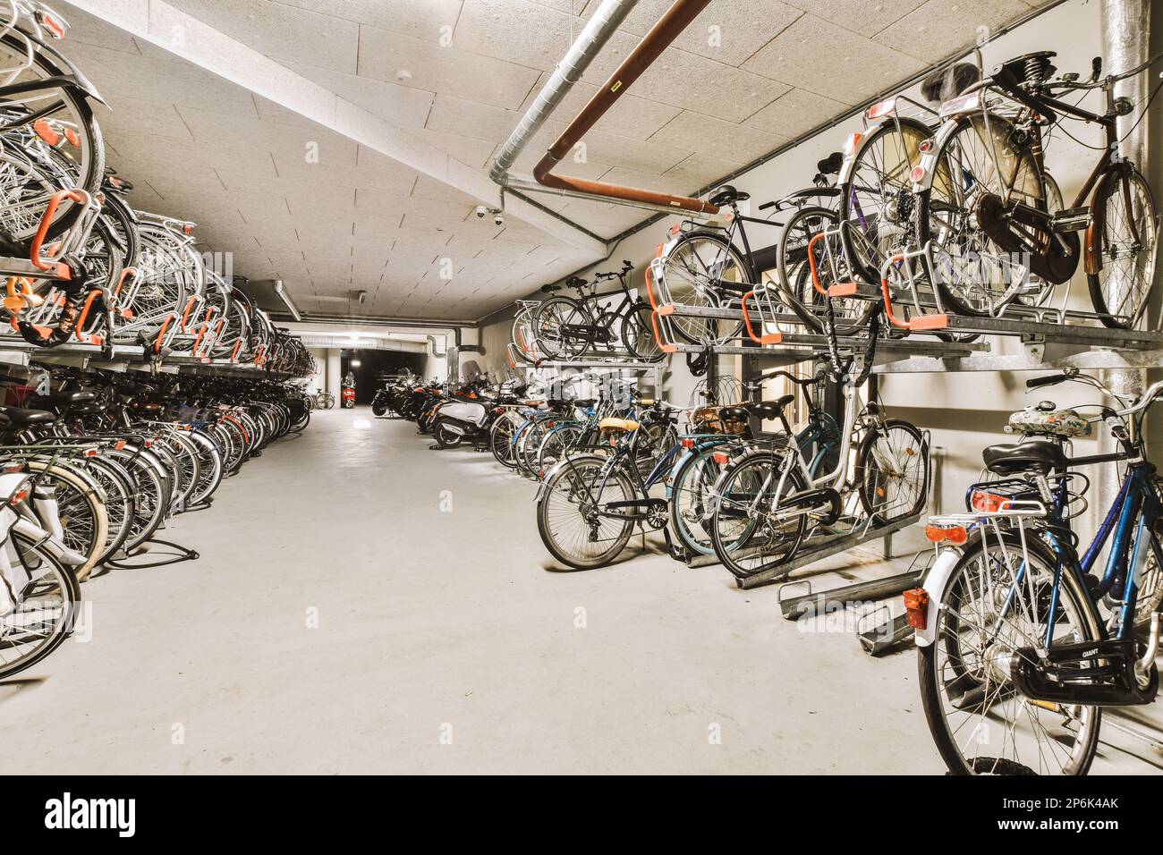 many bikes parked in a bike storage area, all stacked up and ready to be stored on the wall or ...