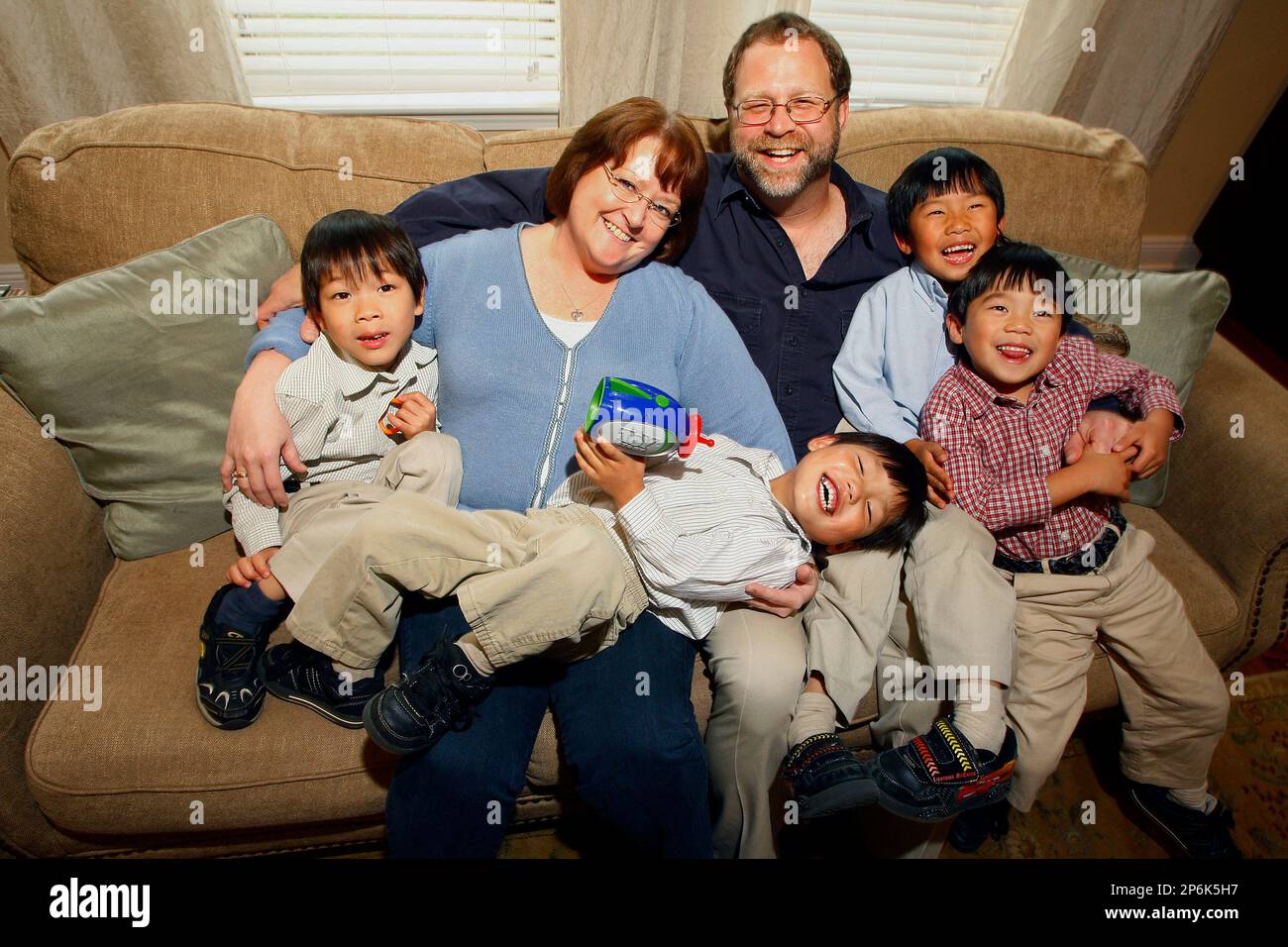In this undated photo, Renee and Nick Schmidt pose for a picture with their adopted sons at ...