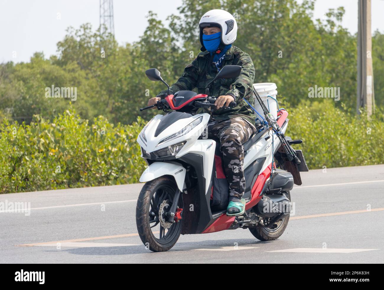 BANGKOK, THAILAND, FEB 07 2023, A man in camouflage wear is riding a ...