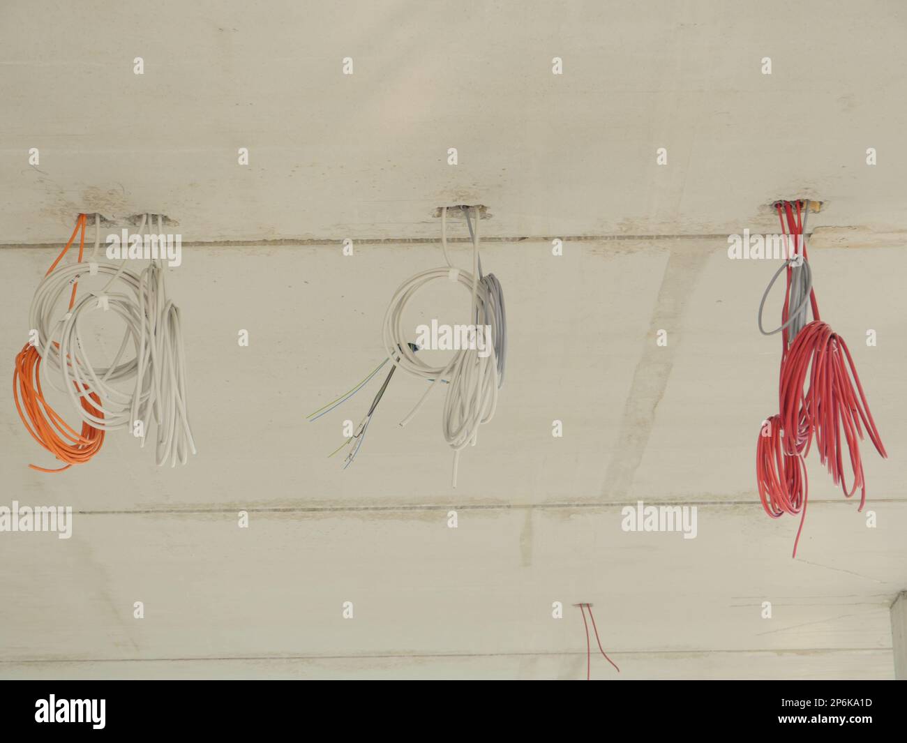 Two rolled wires sticking out of ceiling Stock Photo - Alamy