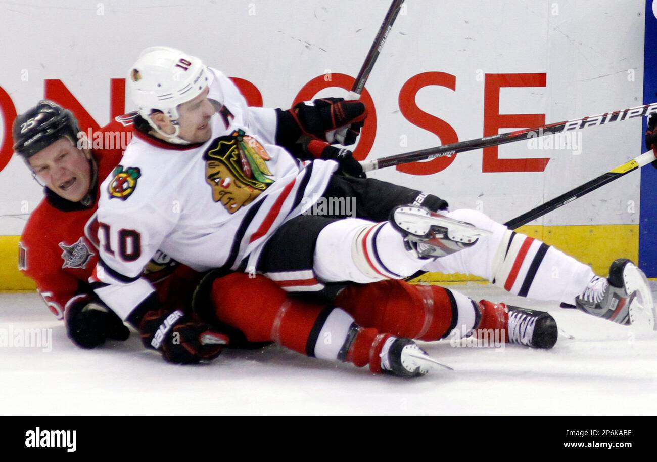 Ottawa Senators' Chris Neil, left, reacts after colliding with Chicago ...