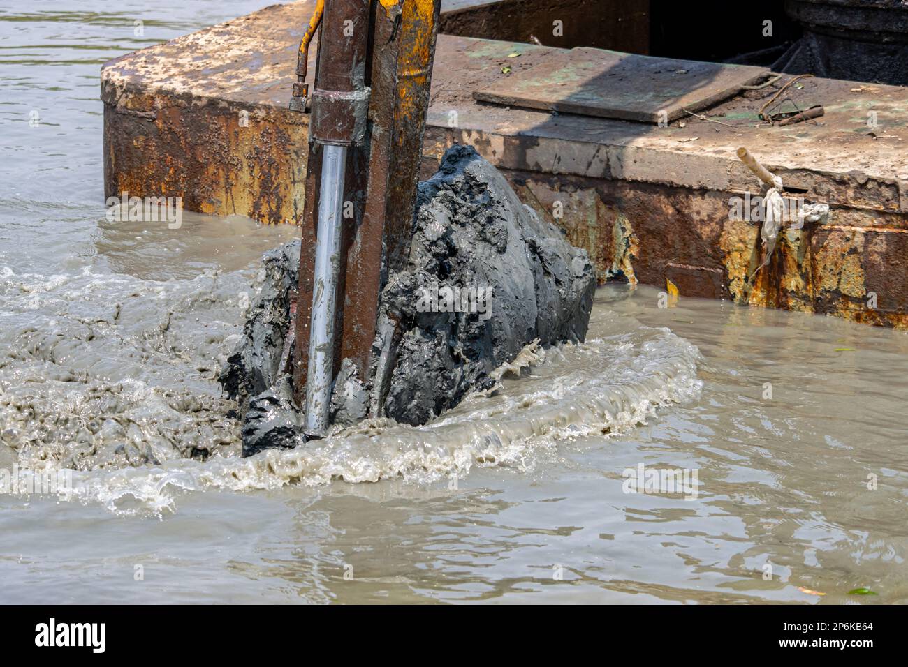 Dredging the bottom of water area, view of the bucket of the floating ...