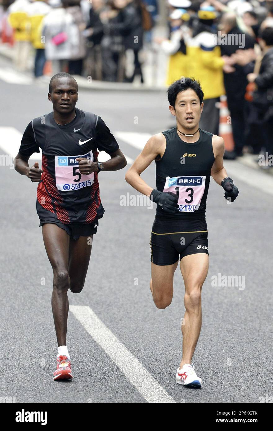 Japan's Arata Fujiwara (R) competes heading for the goal of the Tokyo ...