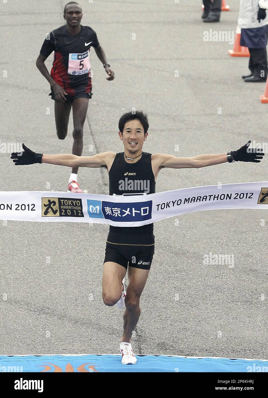 Japanese runner Arata Fujiwara crosses the goalline at Tokyo Big Sight ...