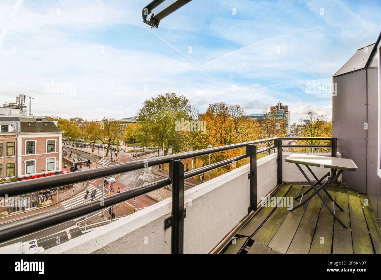 a balcony with some buildings in the background and a bird flying ...