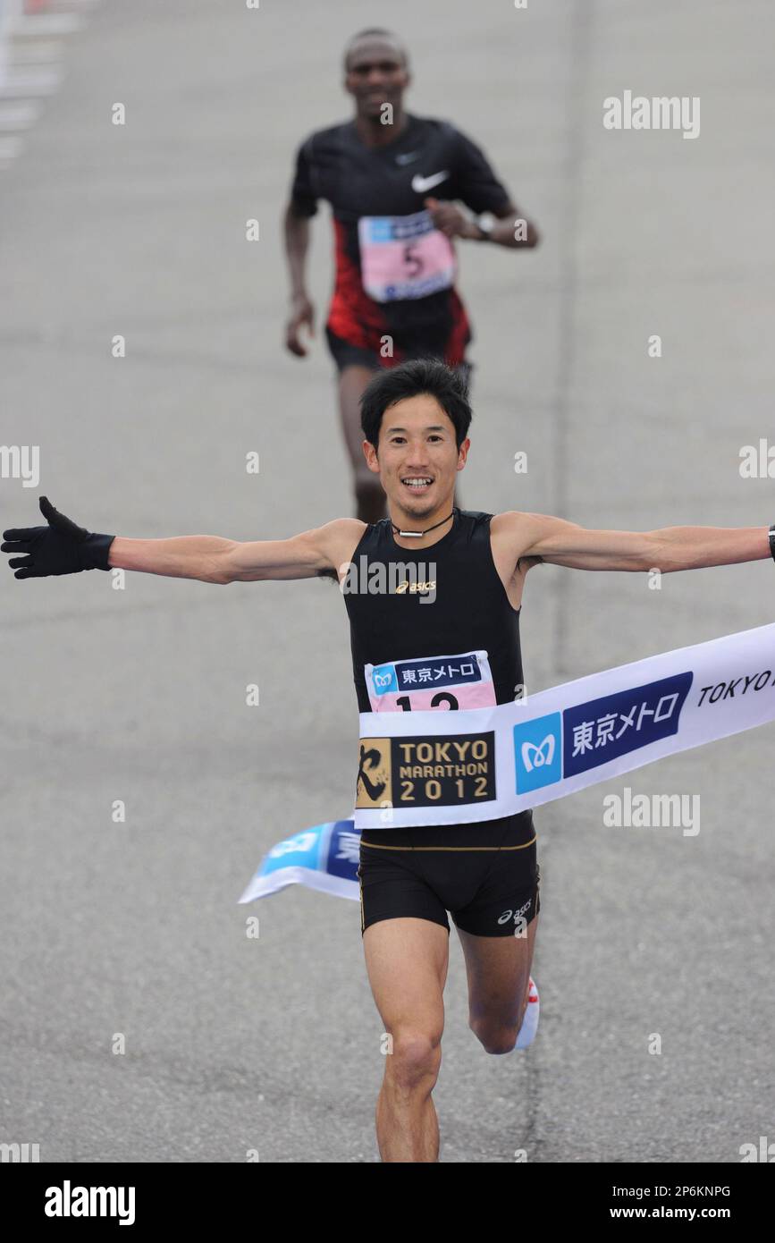 Arata Fujiwara of Japan crosses the finish line to place second in the ...