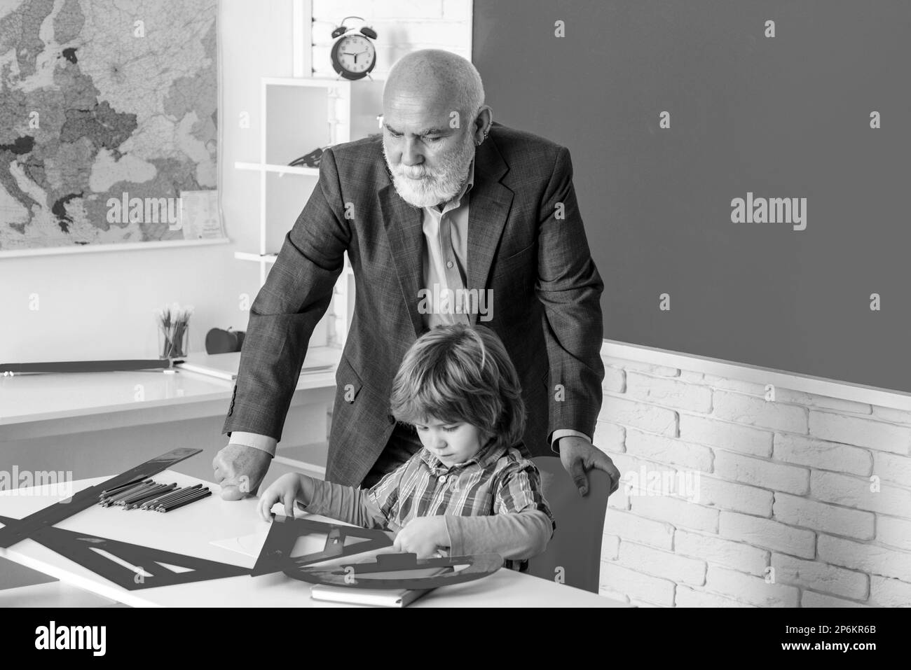 Elementary school. Elementary school teacher giving female pupil ...